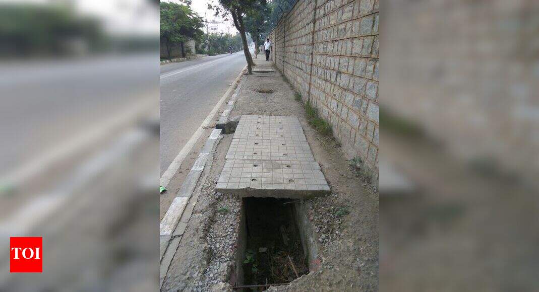 gutter slabs open on footpath - Times of India