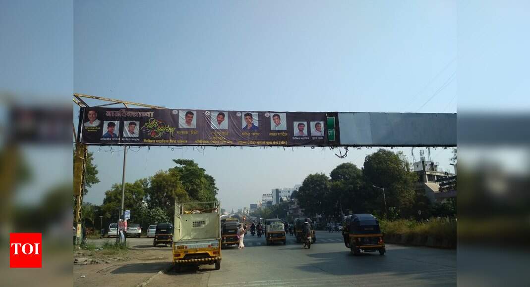 Directions board covered by ugly flex boards - Times of India