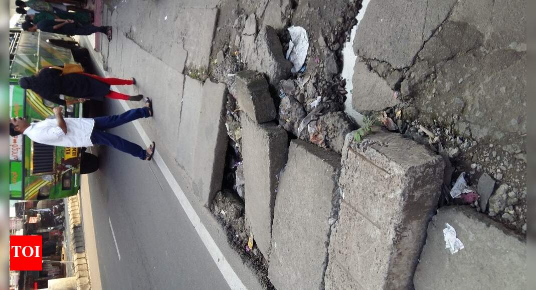 Bad condition of footpath - Times of India