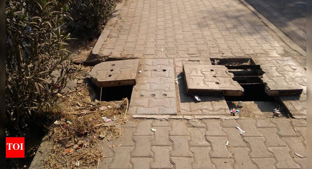 Drain covers on footpath damaged - Times of India