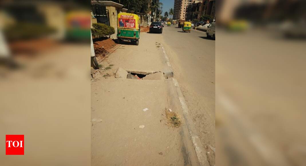 Open gutter on footpath in Hennur mail Road, Benga - Times of India