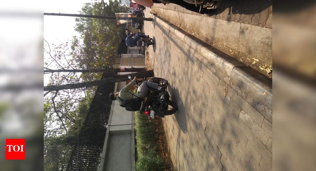 Footpaths become two-wheeler lane in rush hour! - Times of India