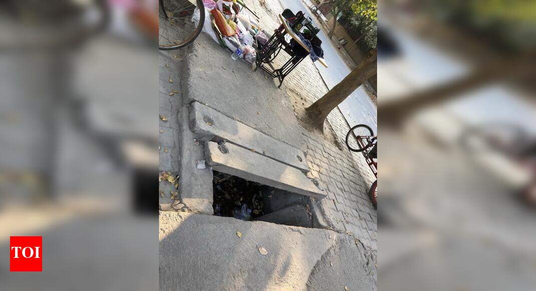Uncovered drain on footpath - Times of India