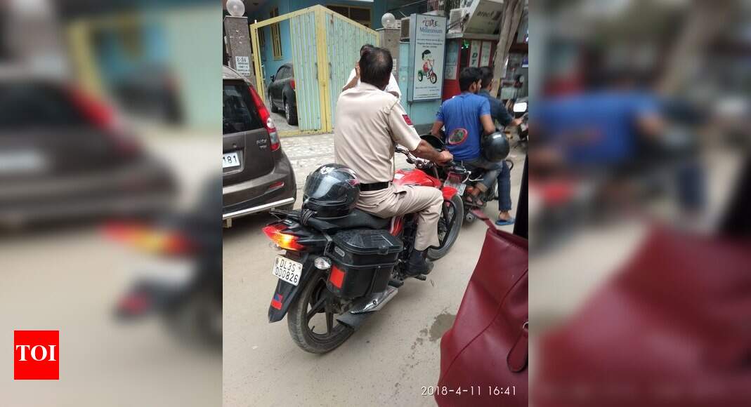 Helmet is cop's pillion rider - Times of India
