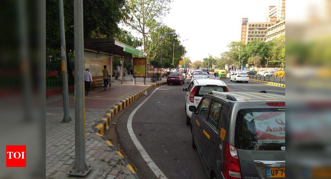 Vehicles block bus stop - Times of India