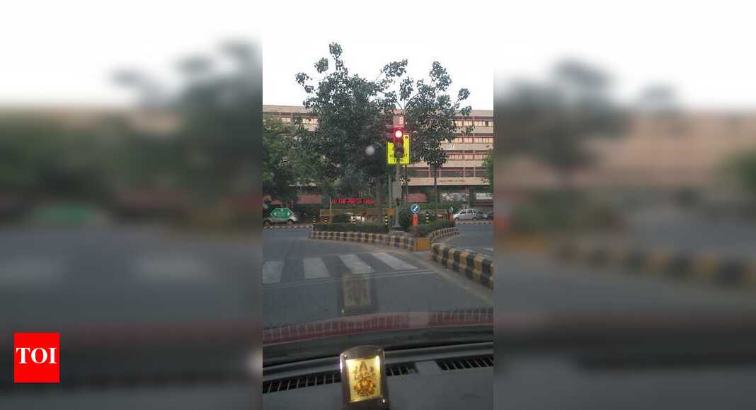 Traffic signal blocks signboard - Times of India