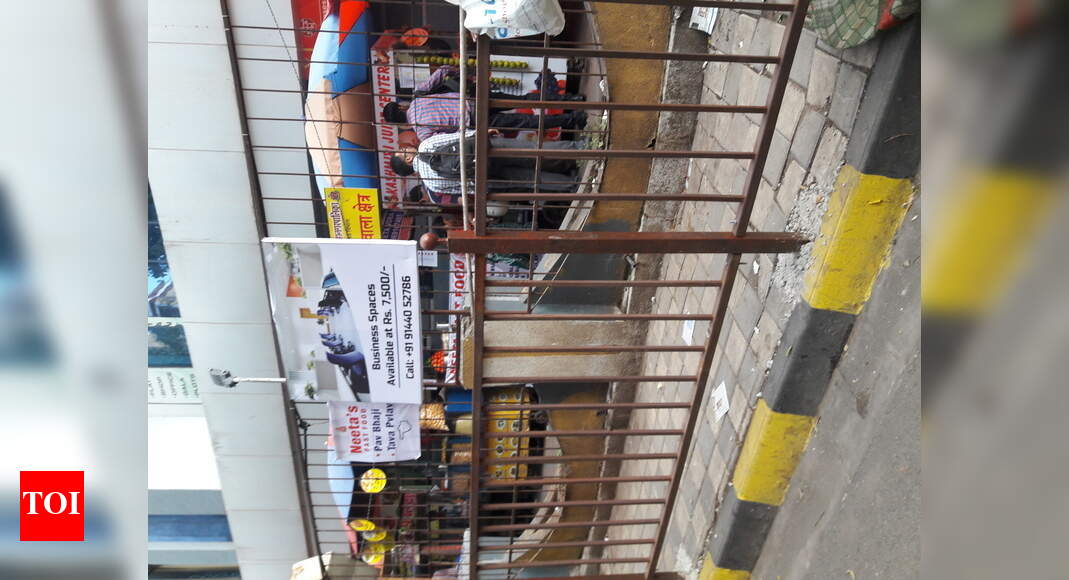 blocking the BMC sign board - Times of India