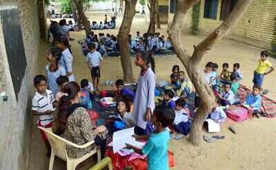 Primary school with 800 students holds classes in open, under trees ...