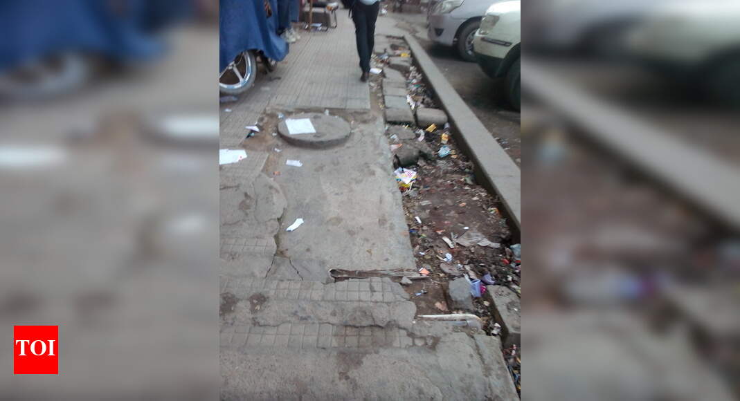Broken footpath - Times of India