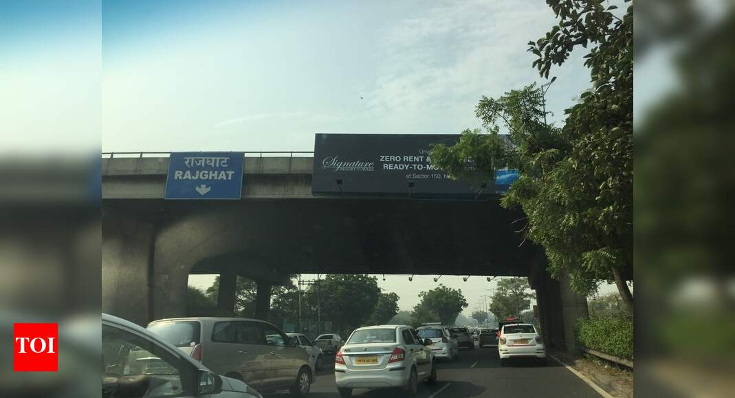 Illegal hoarding covers direction signboard - Times of India