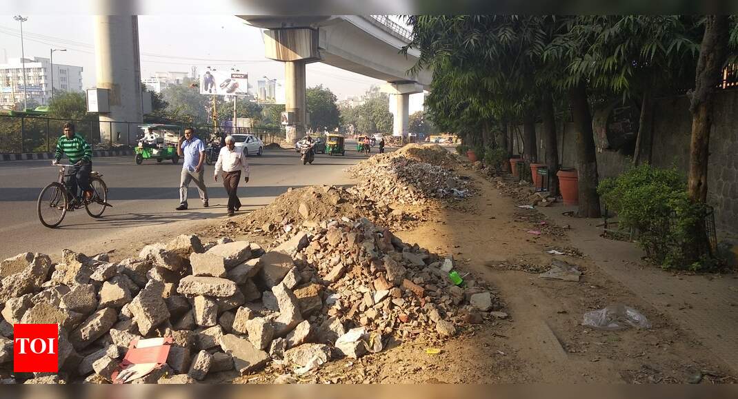 Debris and broken main road - Times of India