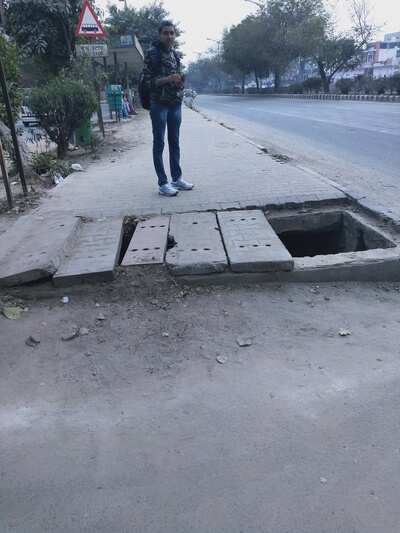 Dangerous footpath with drain covers missing - Times of India