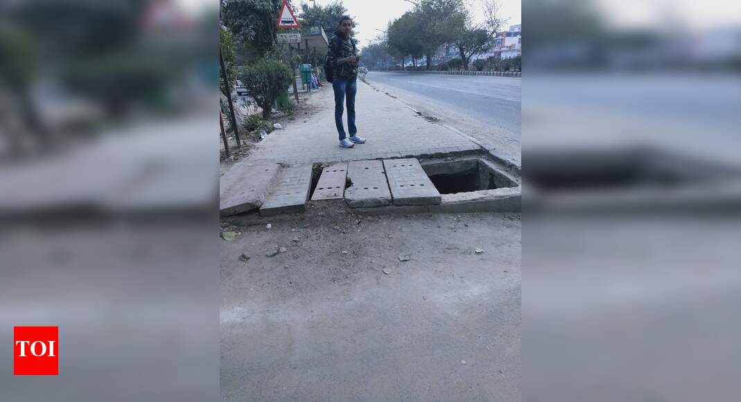 Dangerous footpath with drain covers missing - Times of India