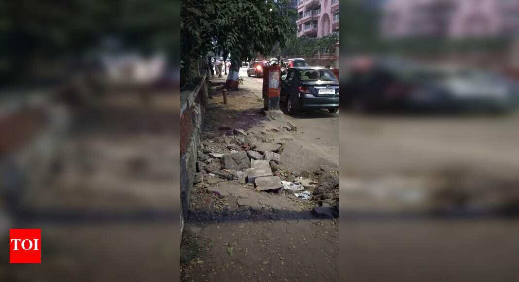 Broken footpath - Times of India
