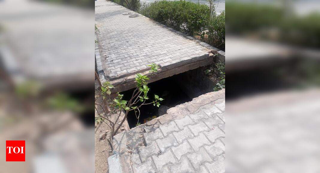Open drain on footpath - Times of India