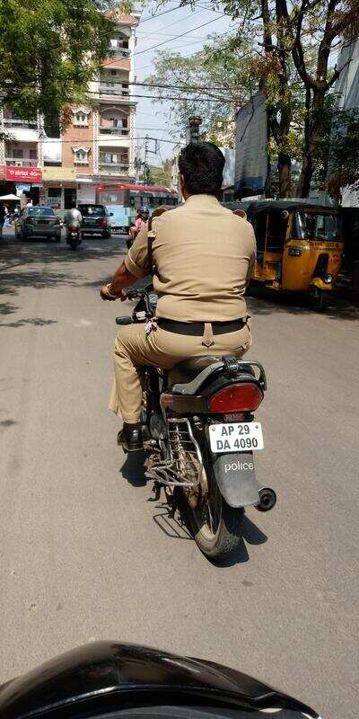Cops permitted to ride bike without helmet - Times of India