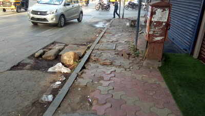 Footpath damaged - Times of India
