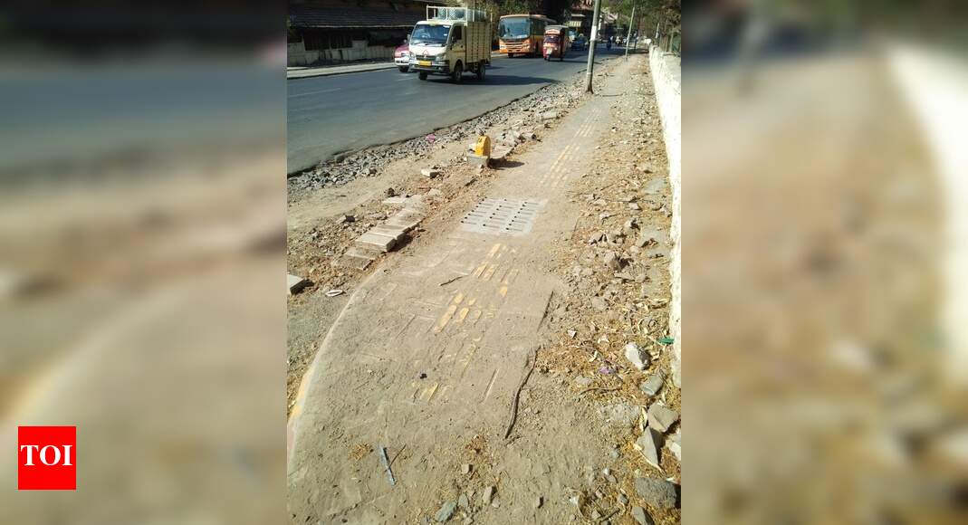 A BROKEN FOOTPATH AND ROAD.. - Times of India