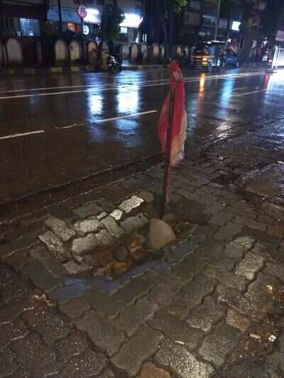 Sinking road....self help flag... - Times of India