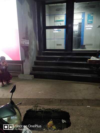 A big gaping hole in the pedestrian path - Times of India