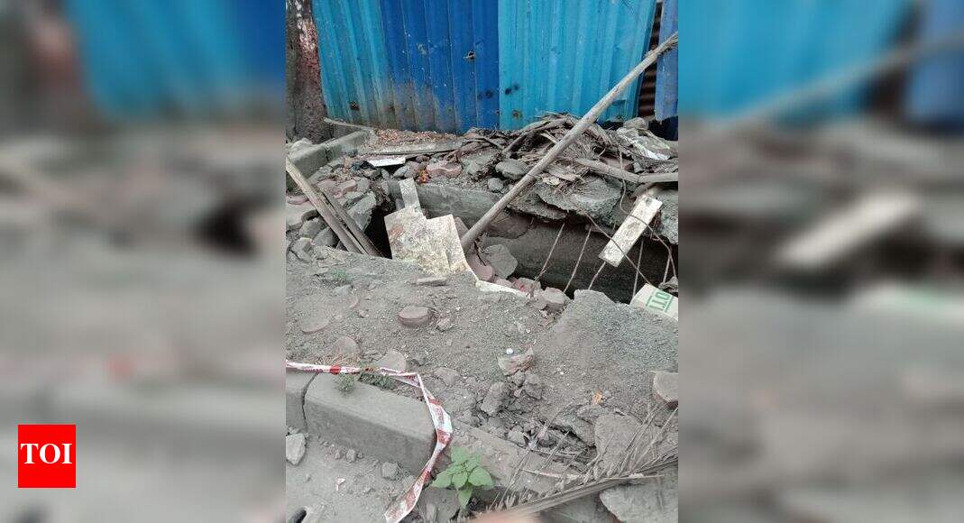 broken footpath with massive holes - Times of India