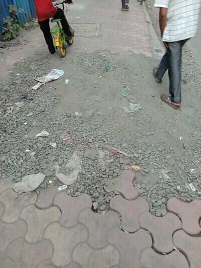 broken footpath with massive holes - Times of India