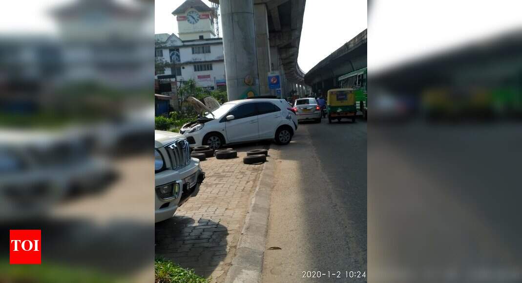 Cars parked and repaired on the footpath - Times of India