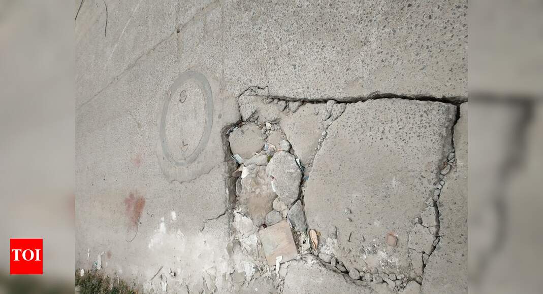 Risky broken drain cover and caved in road - Times of India