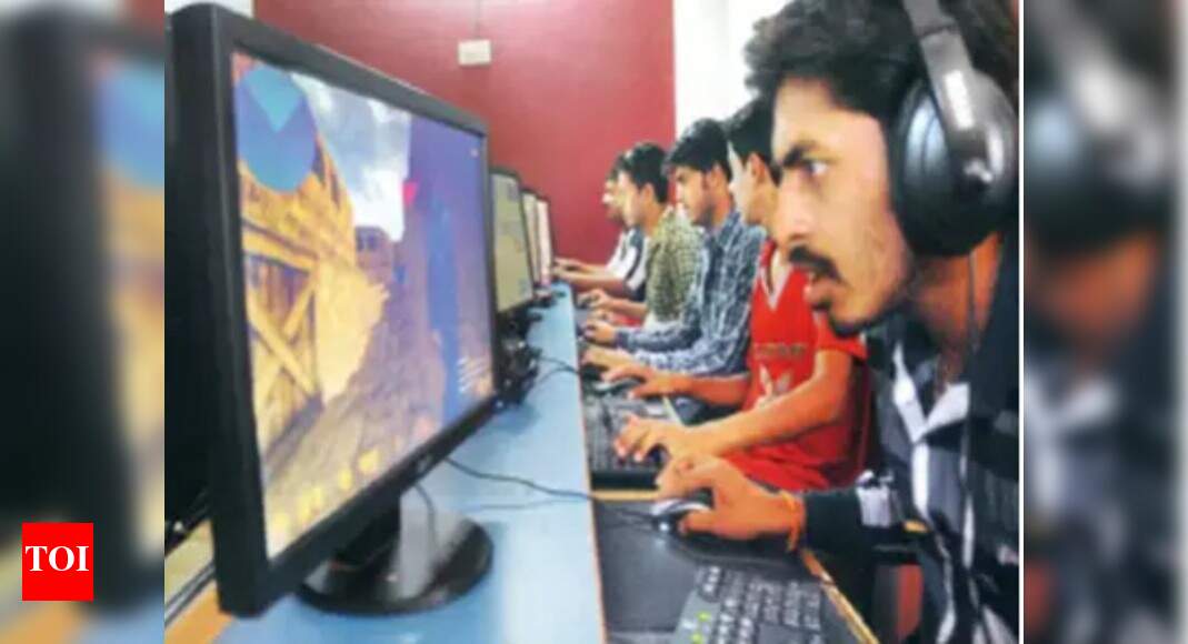 Playing games while eating may cut food intake: Study - Times of India