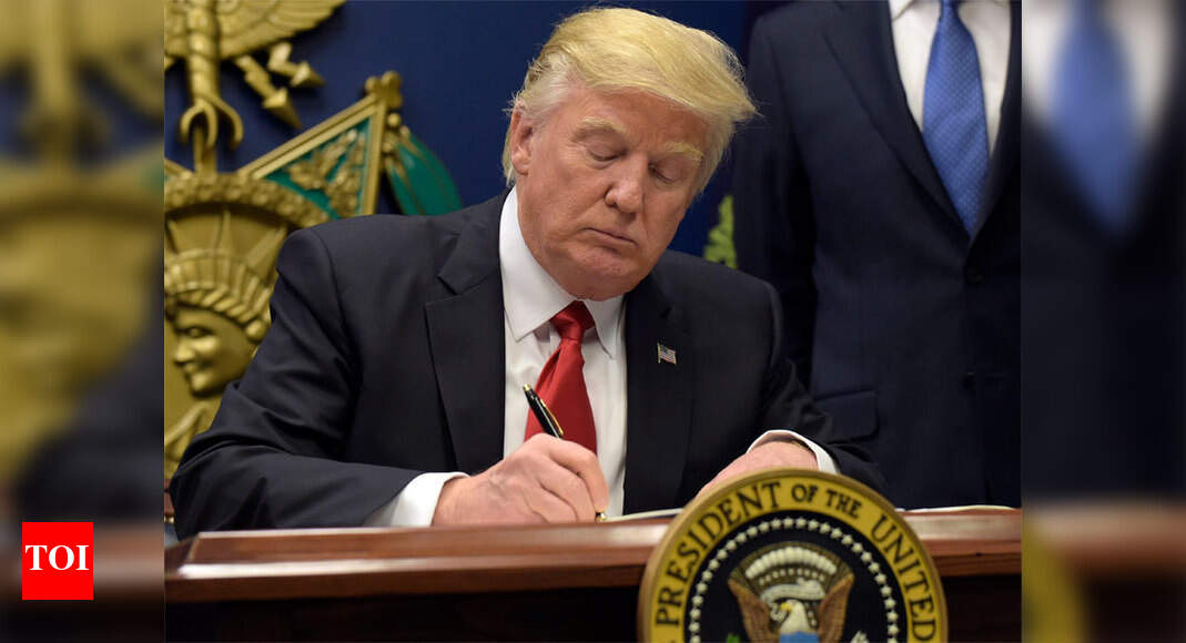 Donald Trump: US President Trump signs $100 billion coronavirus relief ...