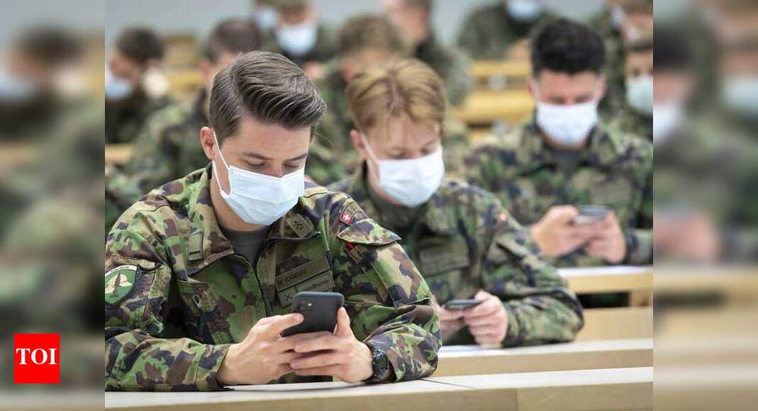 Swiss soldiers pick up smartphones to fight COVID-19 - Times of India