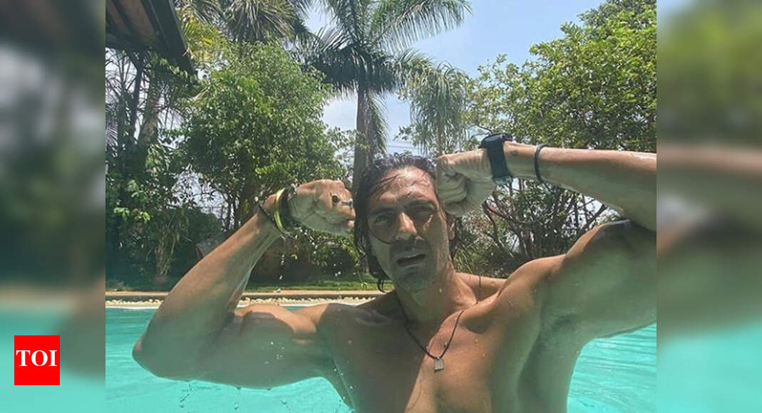 Arjun Rampal shows off his well-chiselled body as he takes a dip in the ...