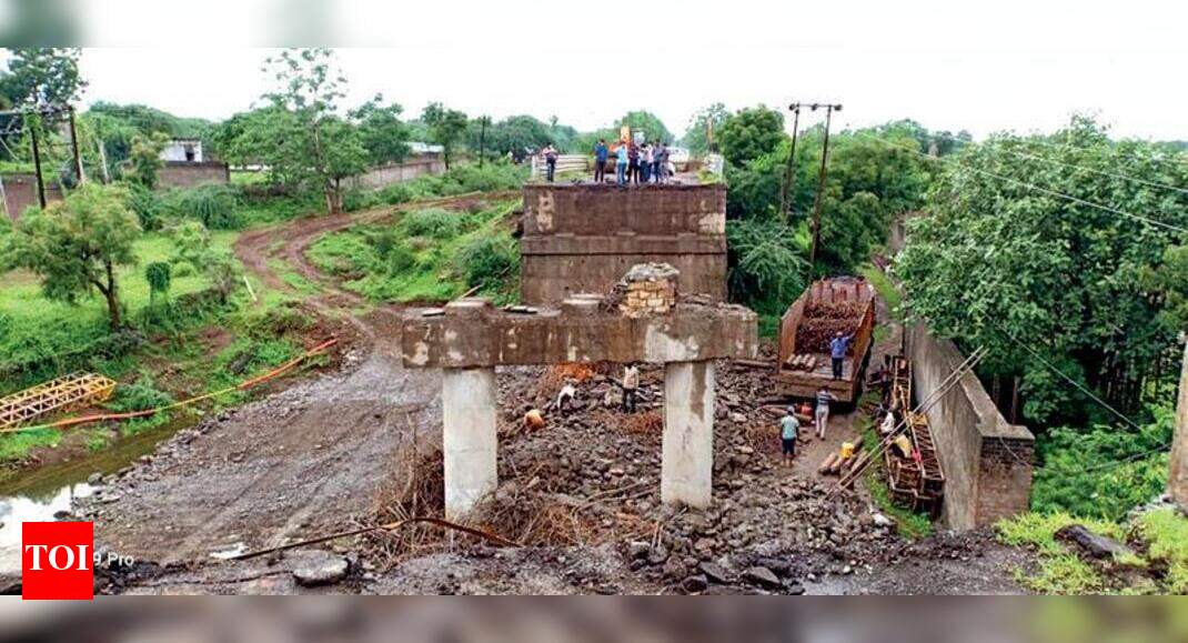 Sans bridge, villagers walk through a river | Rajkot News - Times of India