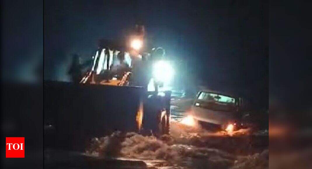 Hyderabad floods: Cops pull out a car stuck in overflowing water using ...