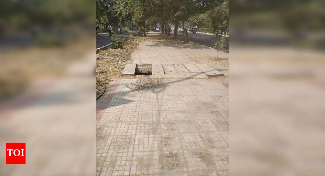 Open drain on footpath - Times of India