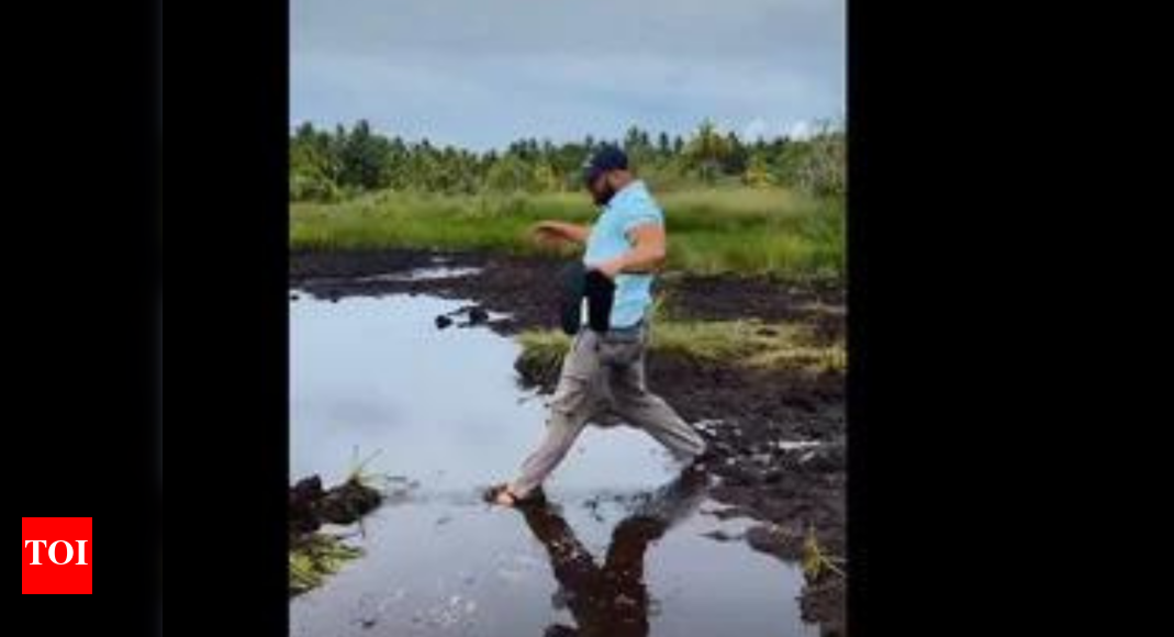 Man falls into a muddy puddle while taking a shortcut, video going ...