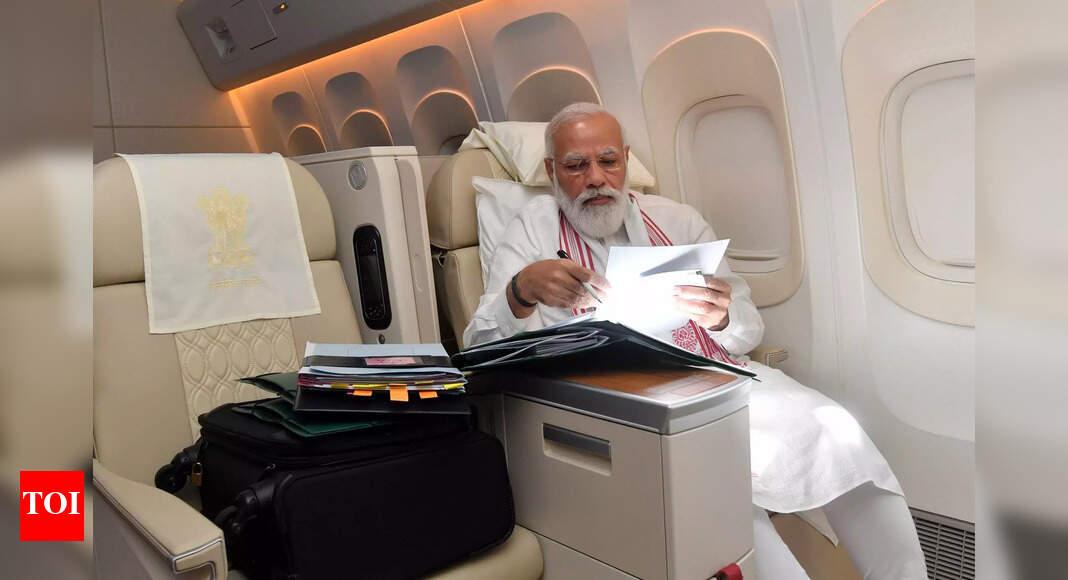 Modi: PM Modi engrossed in paper work during 'long flight' to US ...