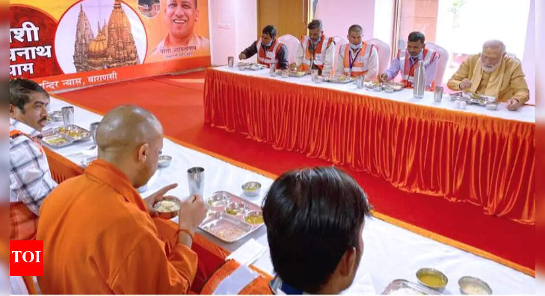 PM Narendra Modi showers flower petals on construction workers, breaks ...