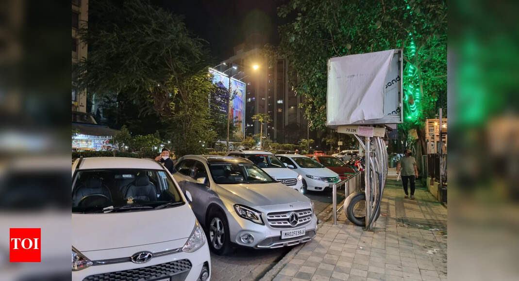 Luxury cars blocking a bus stop - Times of India