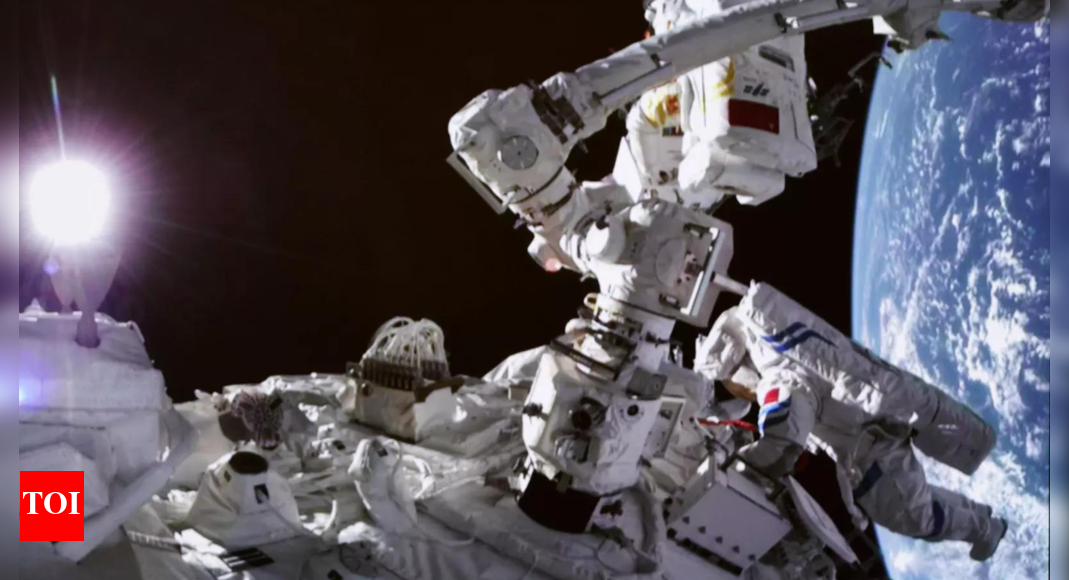 Chinese astronauts go on spacewalk from new station - Times of India