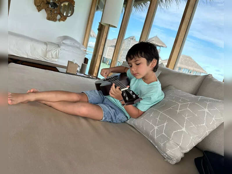 Taimur plays ukelele as he holidays with daddy Saif Ali Khan in ...